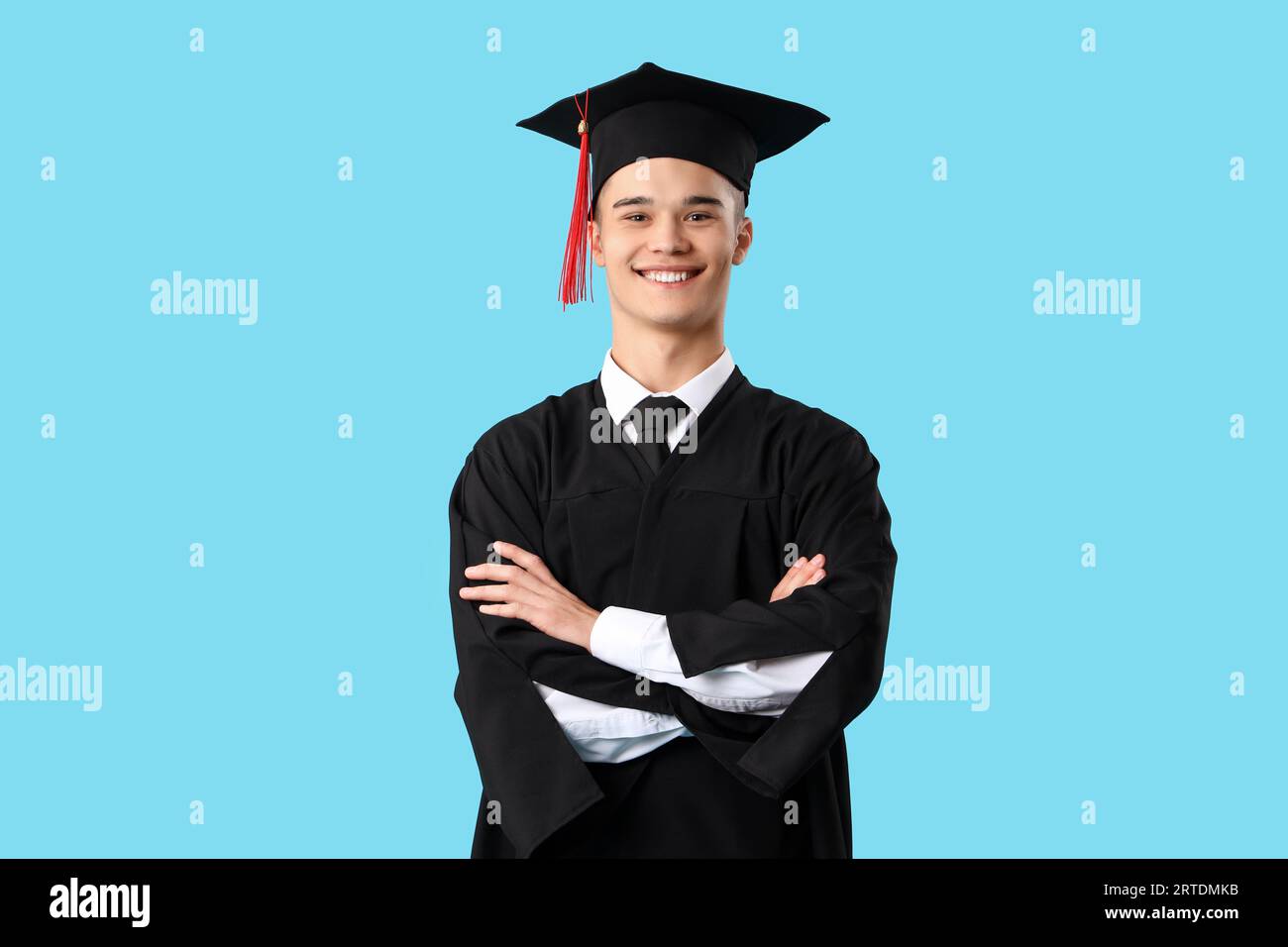 Male graduate student on blue background Stock Photo - Alamy