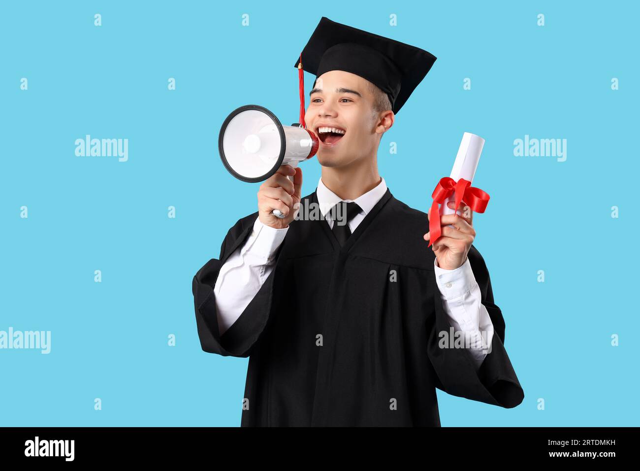 Male graduate student with diploma shouting into megaphone on blue ...