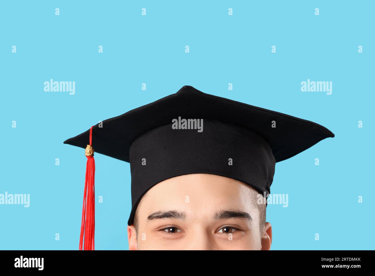 Male graduate student on blue background, closeup Stock Photo - Alamy