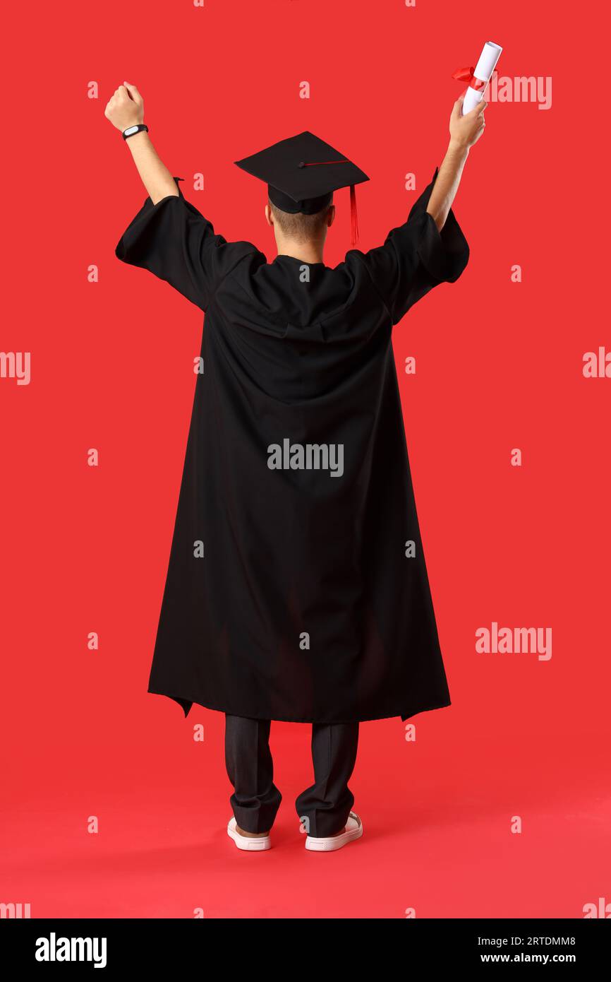 Happy male graduate student with diploma on red background, back view ...