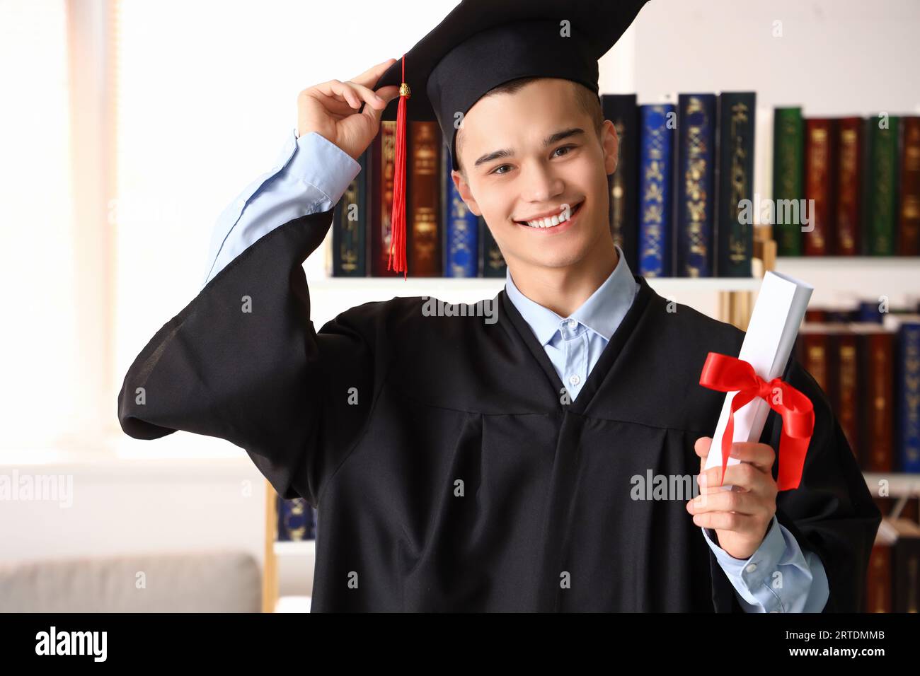 Male graduate student with diploma at university Stock Photo - Alamy