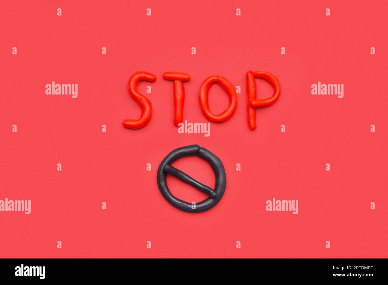 Red word STOP with sign made of play dough on red background Stock ...