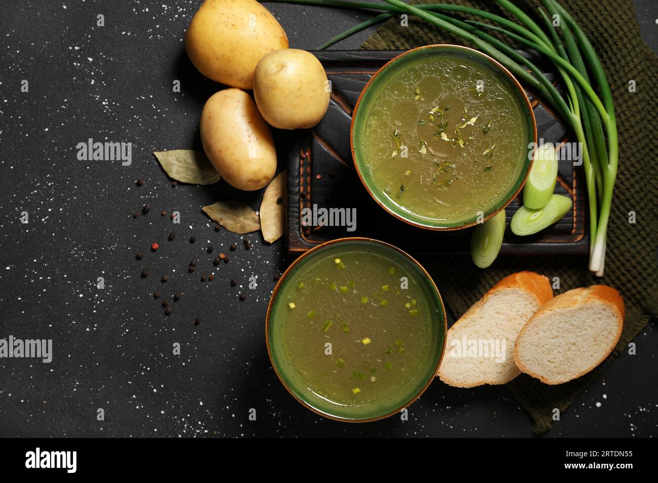 Bowls of tasty vegetable broth on black background Stock Photo - Alamy