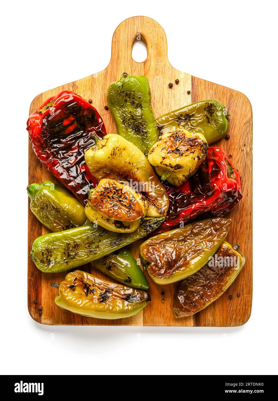 Wooden board with different grilled peppers on white background Stock ...