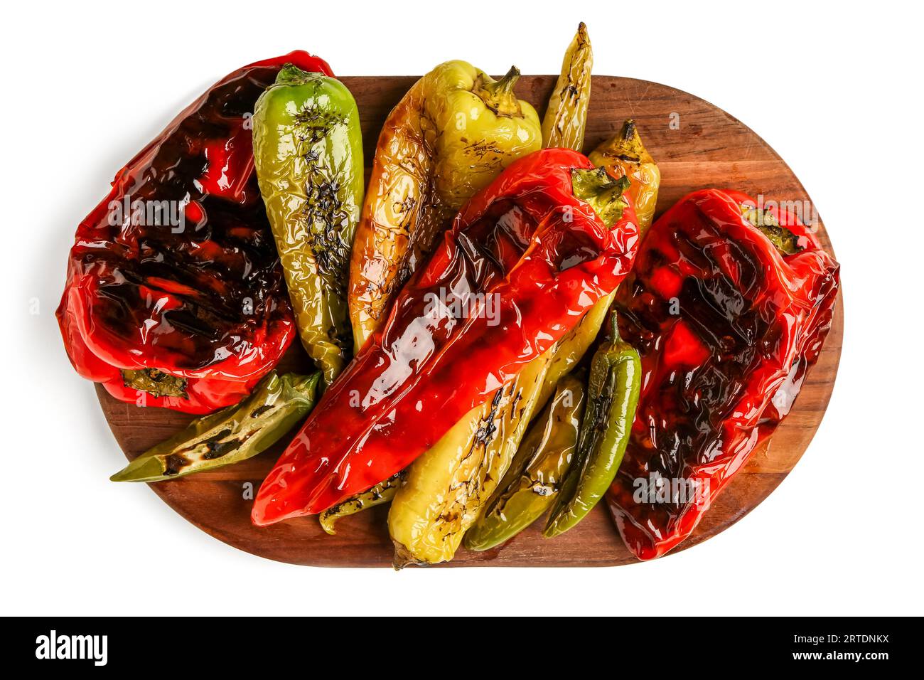 Wooden board with different grilled peppers on white background Stock ...