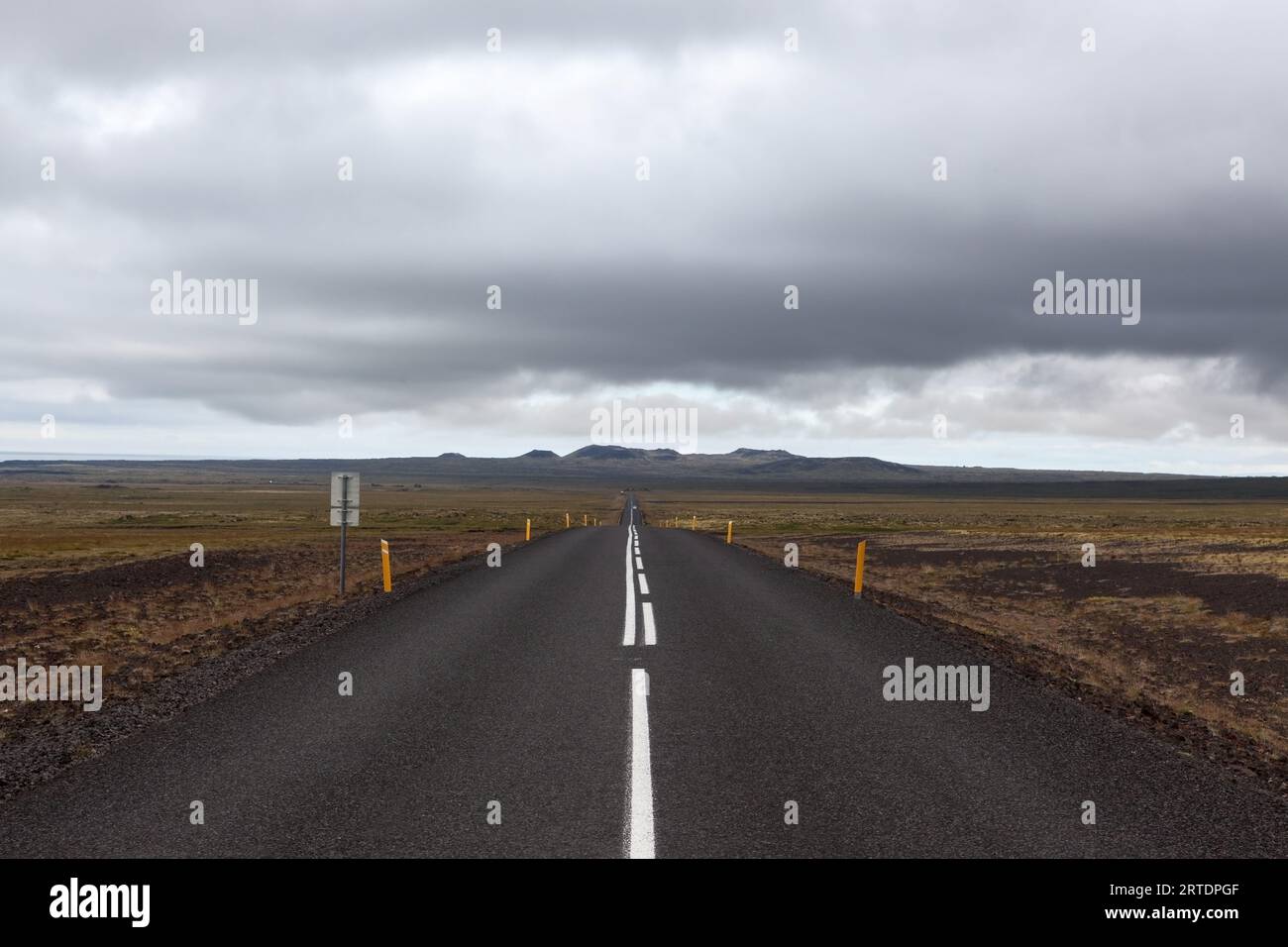 Iceland road leading straight to the far away mountains. Empty straight ...