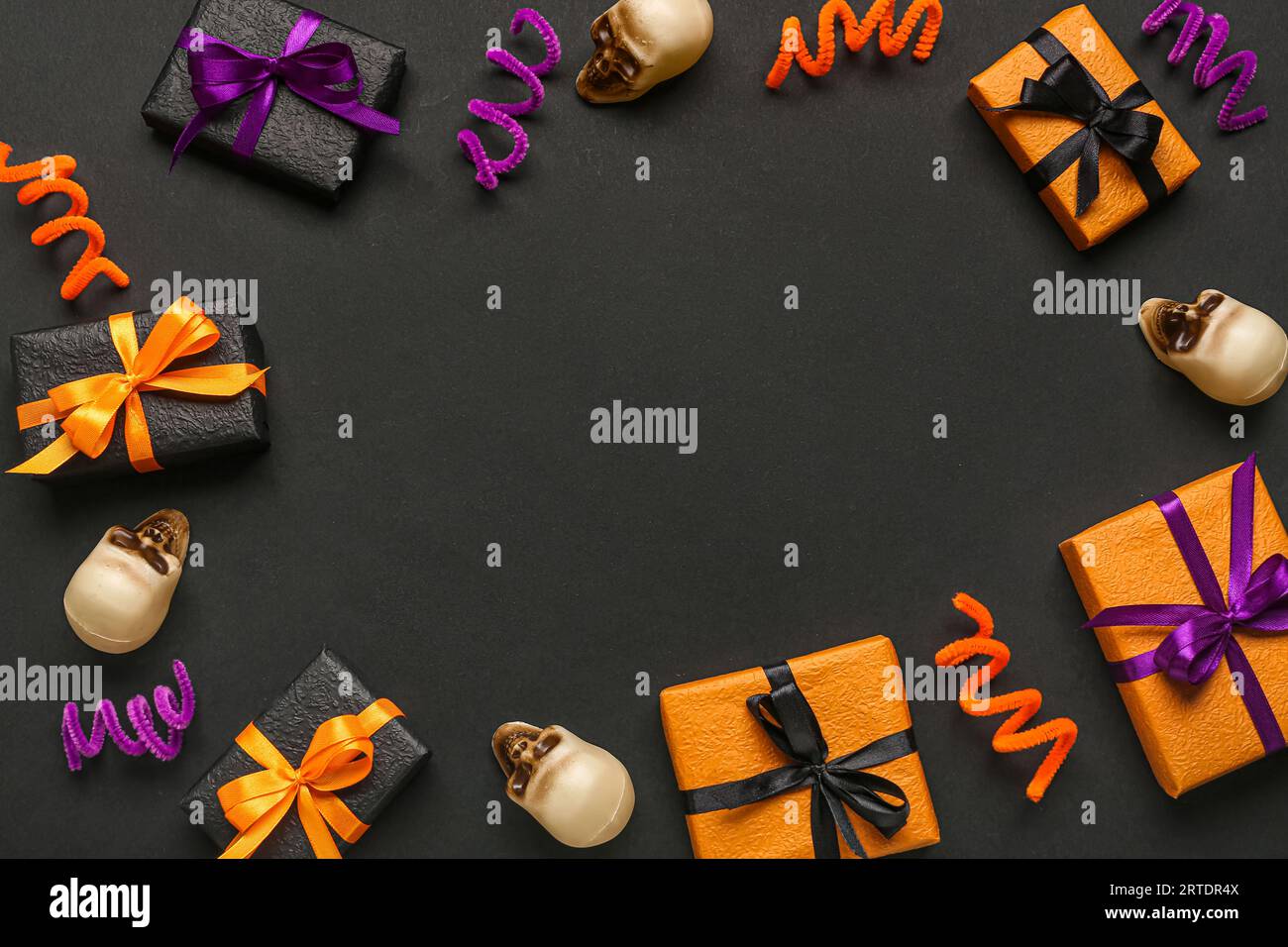 Frame made of gift boxes, skulls and Halloween decoration on black ...