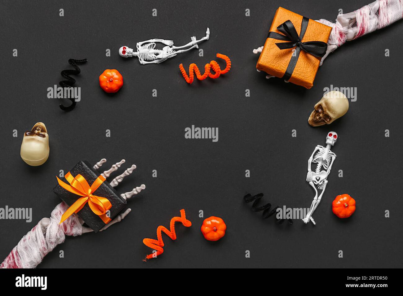 Frame made of gift boxes, skeleton hands, skulls and Halloween ...