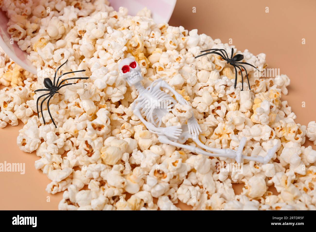 Bucket with tasty popcorn, spiders and skeleton for Halloween ...
