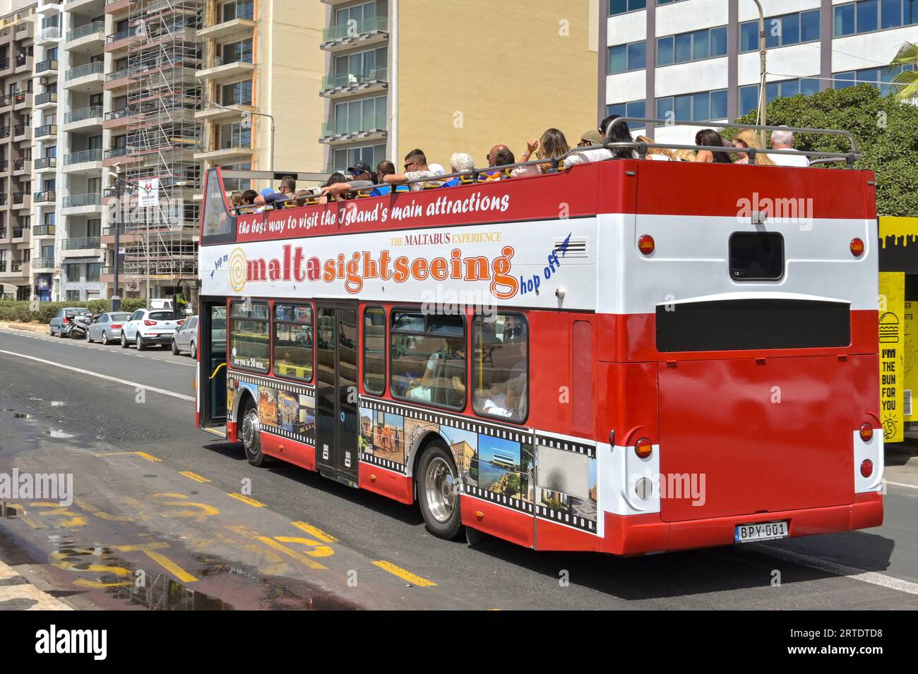 Sliema, Malta - 6 August 2023: People on an open top double decker bus ...