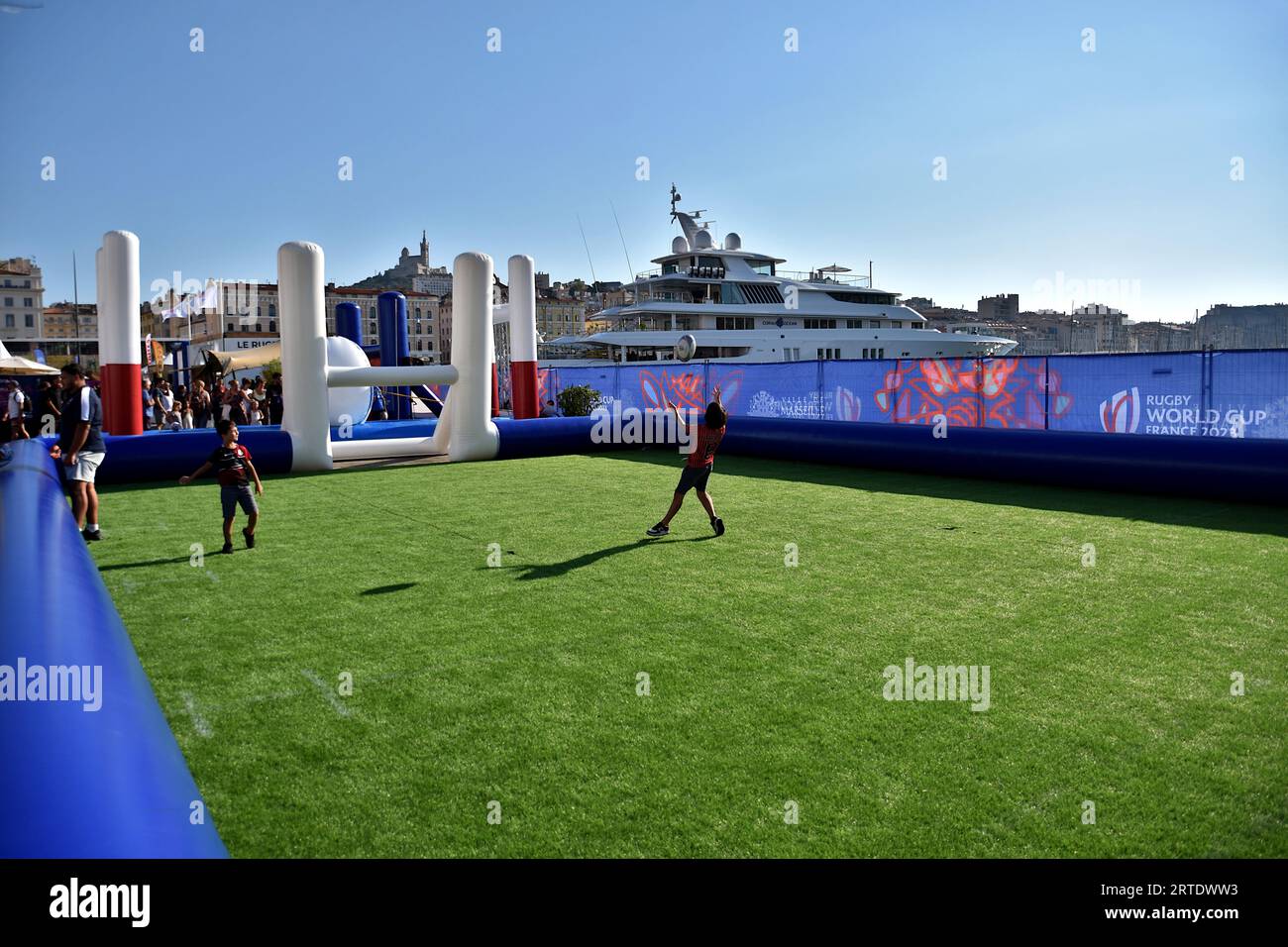 Children play with an oval ball on a playground in the Rugby World Cup ...