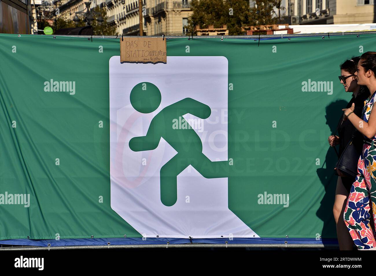 Two women walk past the emergency exit of the Rugby World Cup Village ...
