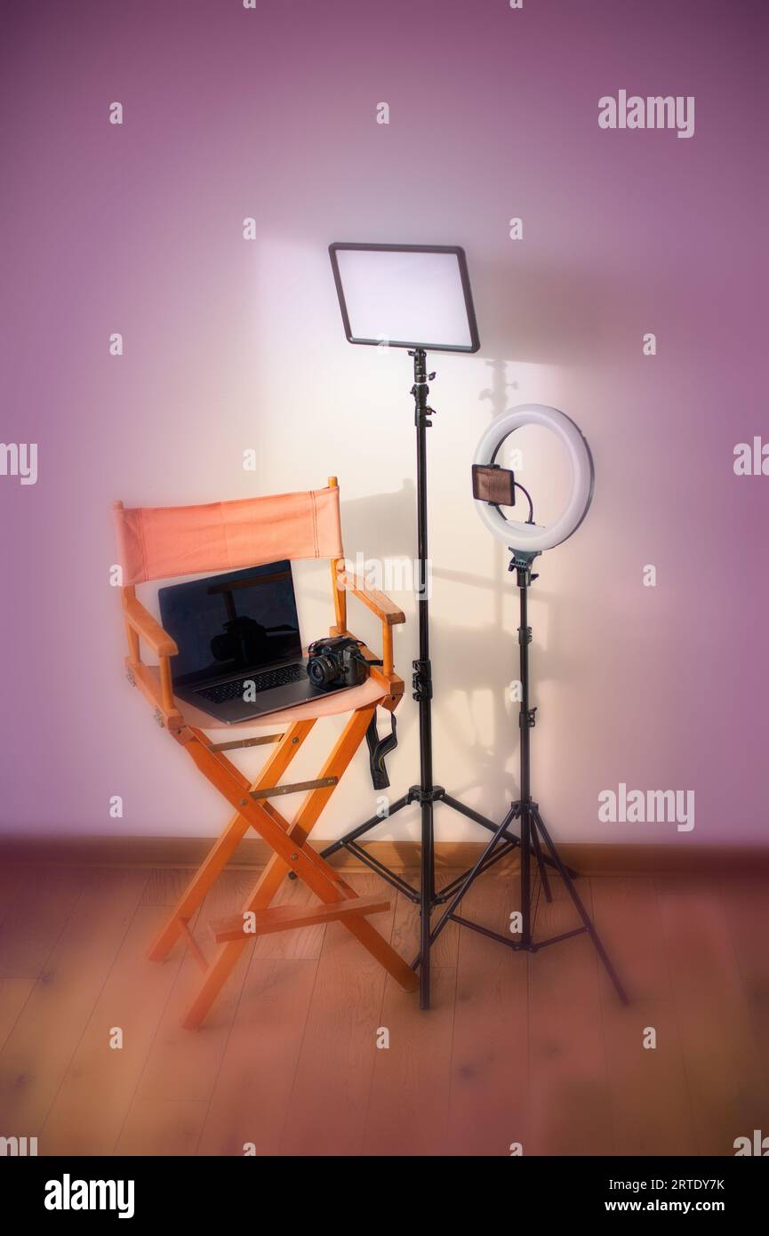 Director's chair, ring lights, digital camera with laptop and hats on ...