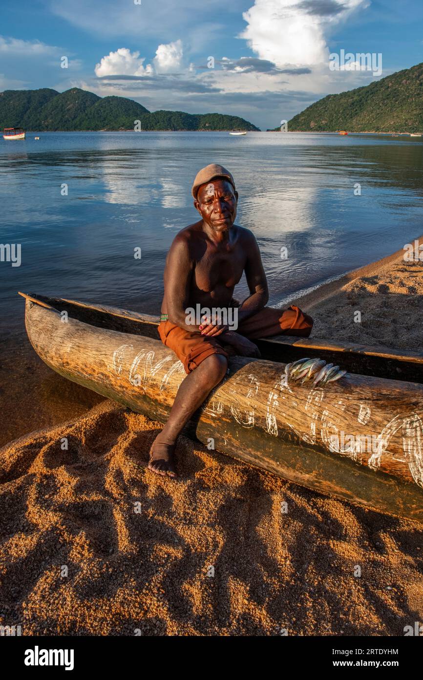 Cape Maclear, Malawi. A fisherman on his dugout canoe on Lake Malawi ...
