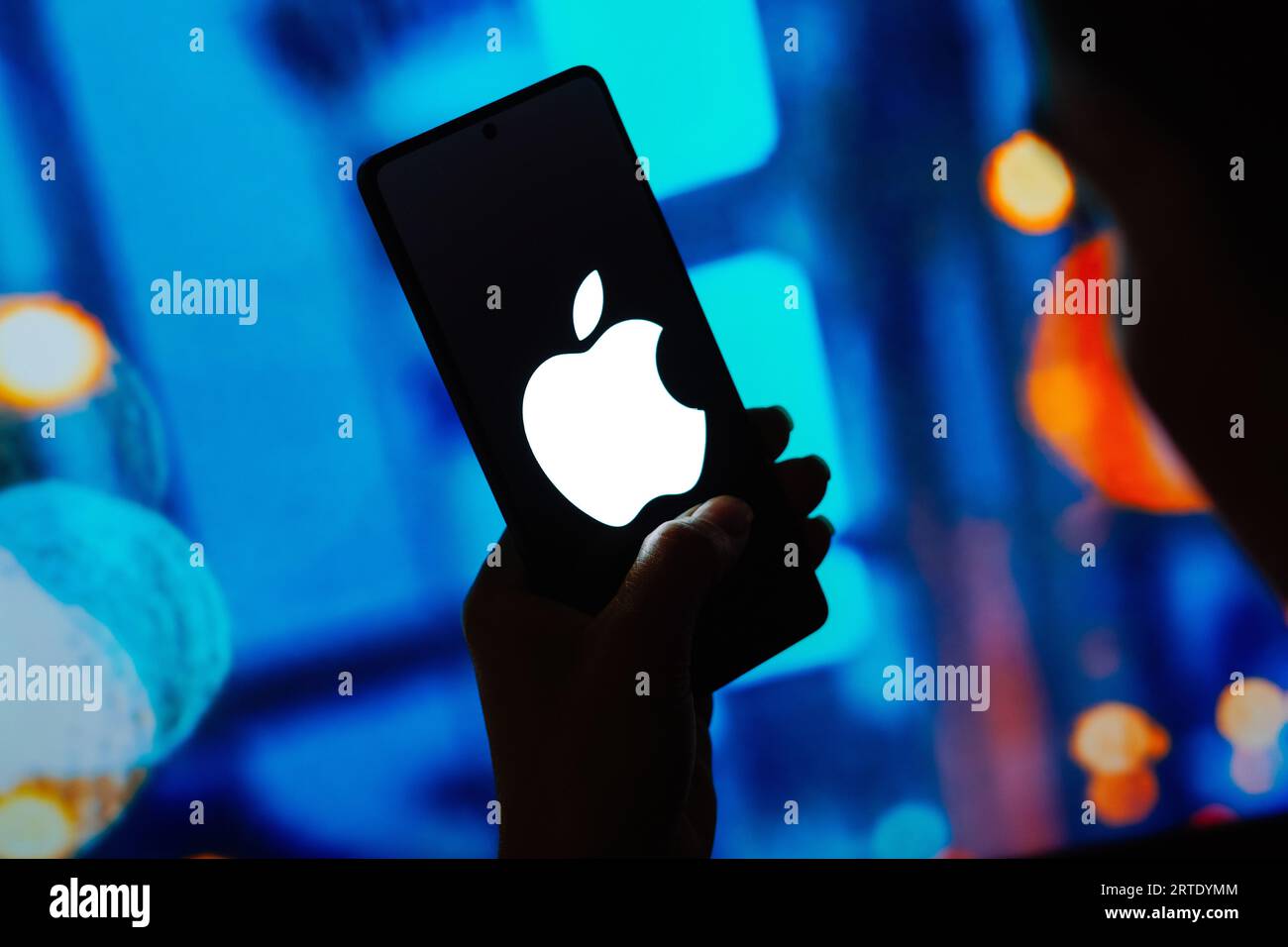 In this photo illustration, the Apple Inc. logo is displayed on a ...