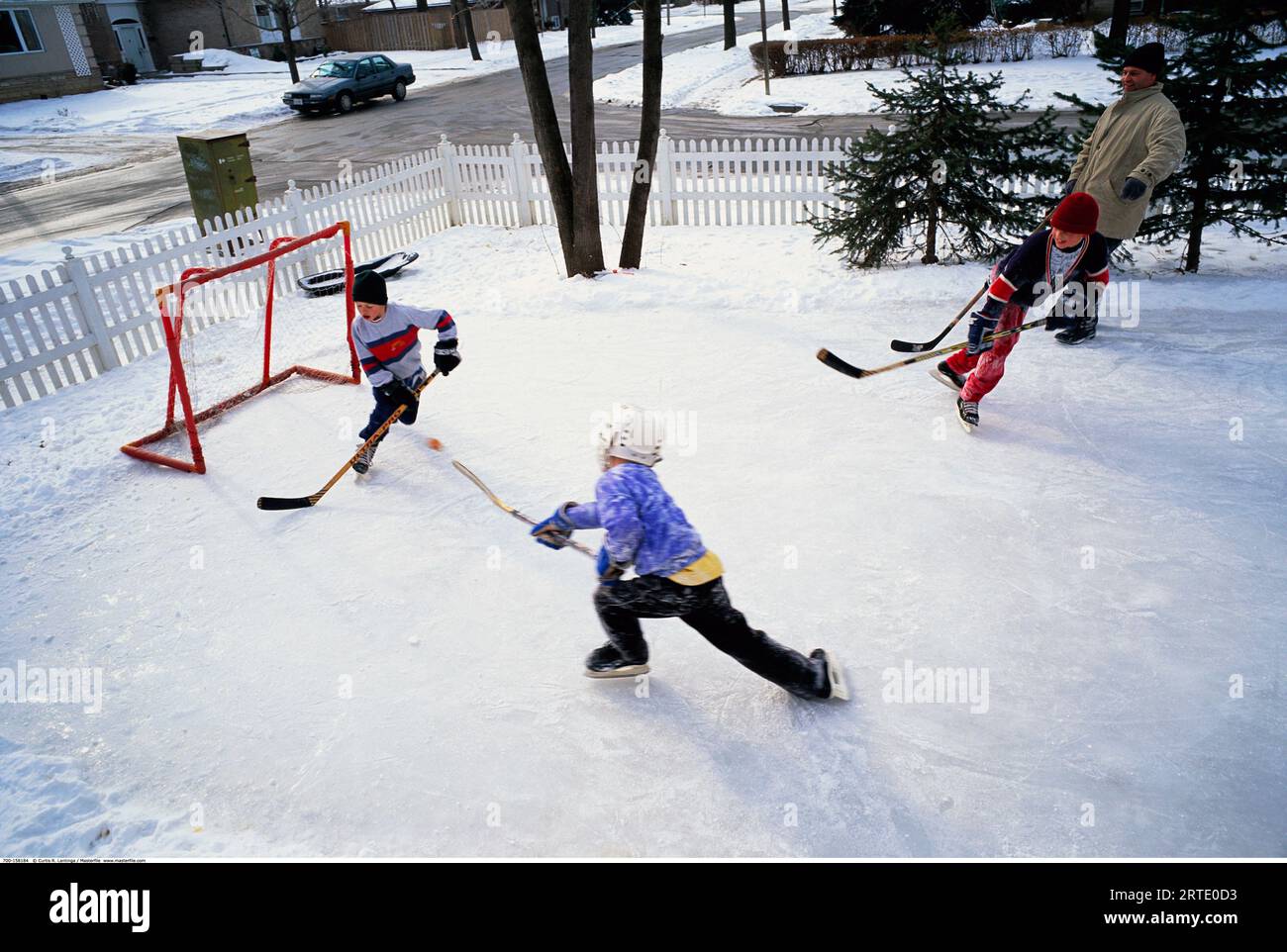 Kids Playing Ice Hockey Outdoors Stock Photo - Alamy