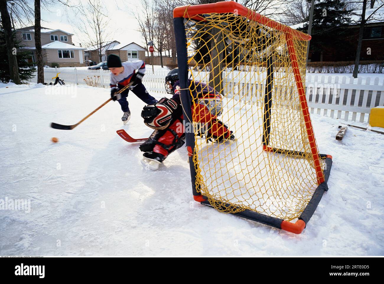Kids Playing Ice Hockey Outdoors Stock Photo - Alamy