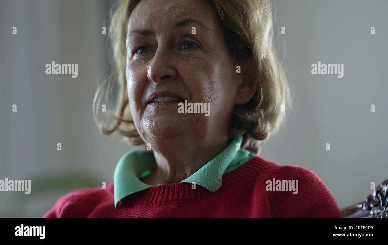 Senior woman listening to conversation nodding yes in affirmation ...