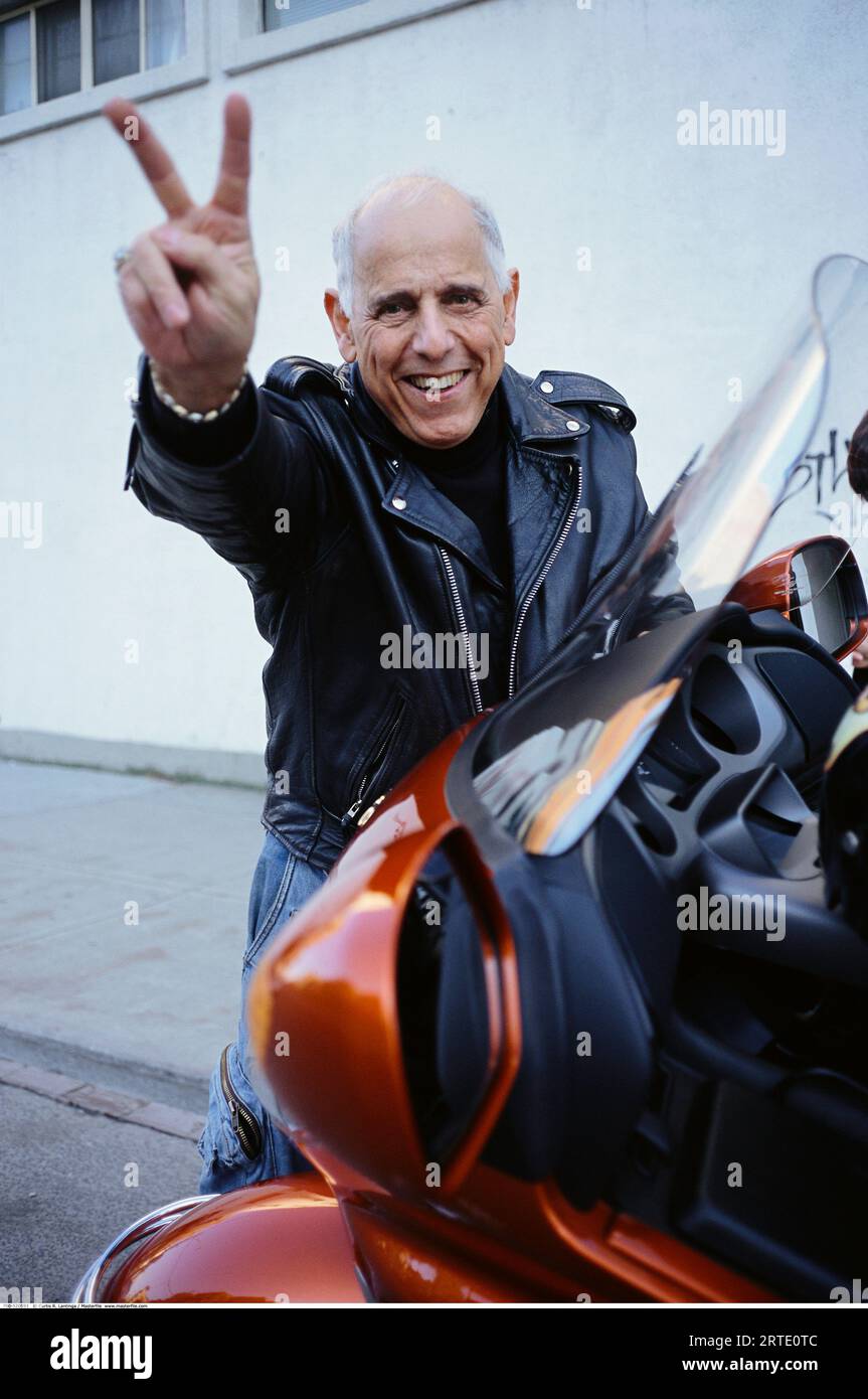 Portrait of Man Giving Peace Sign Stock Photo - Alamy