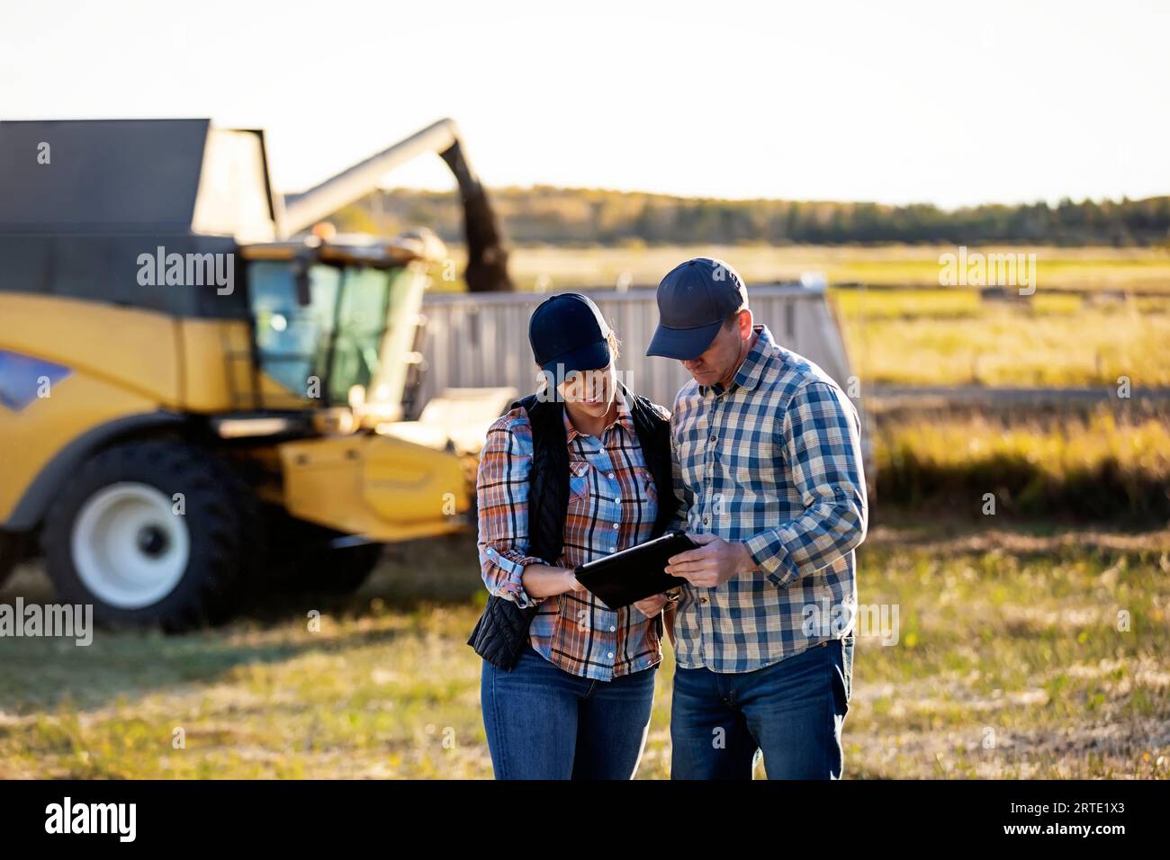 A farm couple using a portable, wireless device to manage and monitor ...