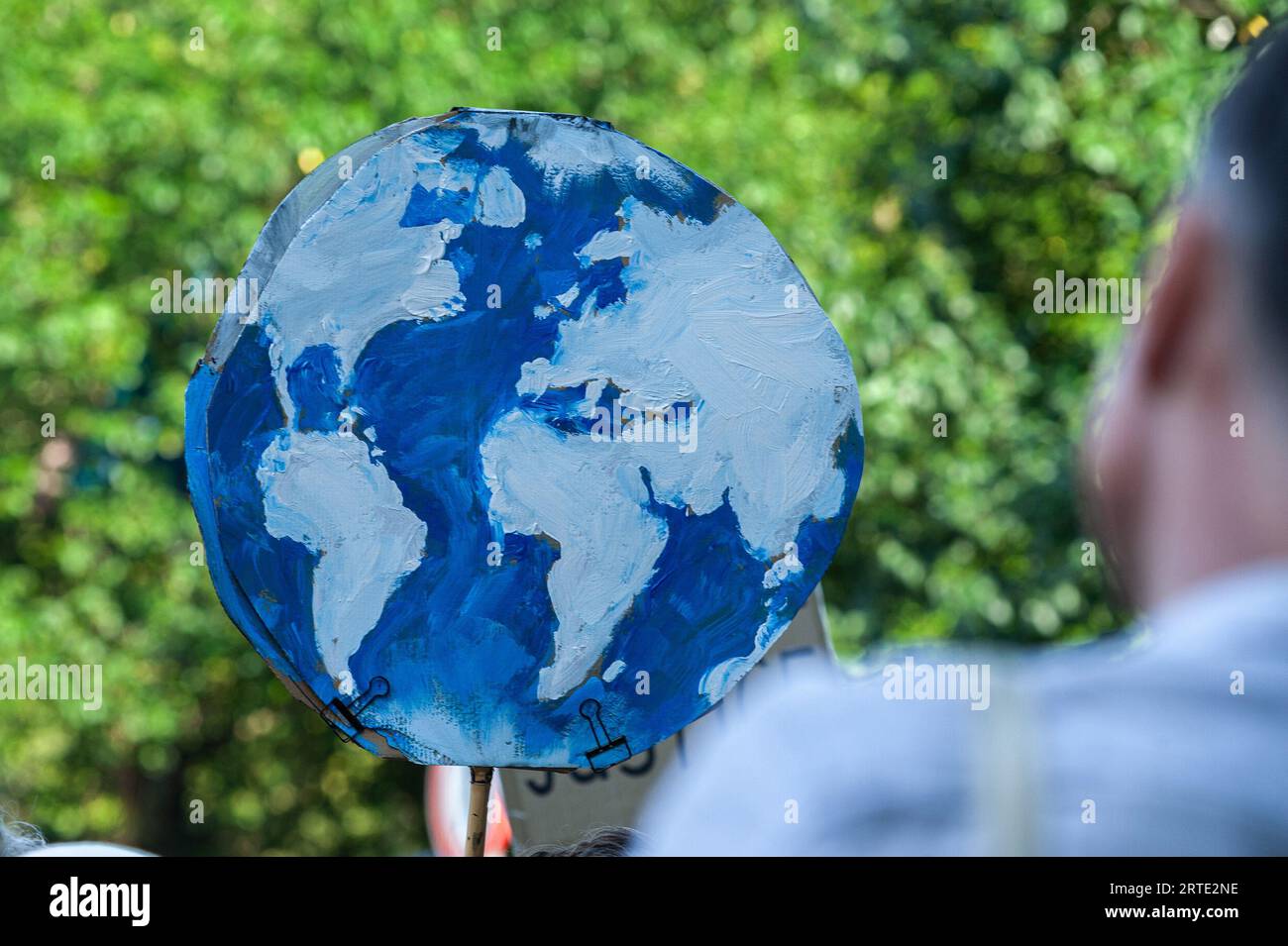 An activist holds a large placard of planet earth, during the non ...