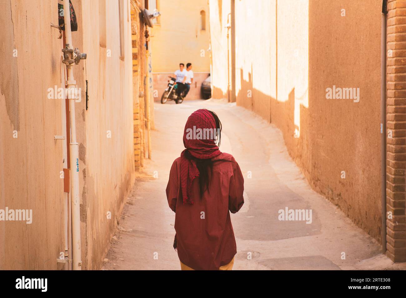 Caucasian woman tourist explore walk through arch corridor in Yazd old ...