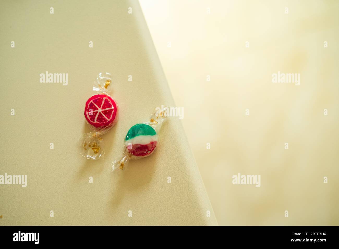 Two colored candies with a white background Stock Photo - Alamy