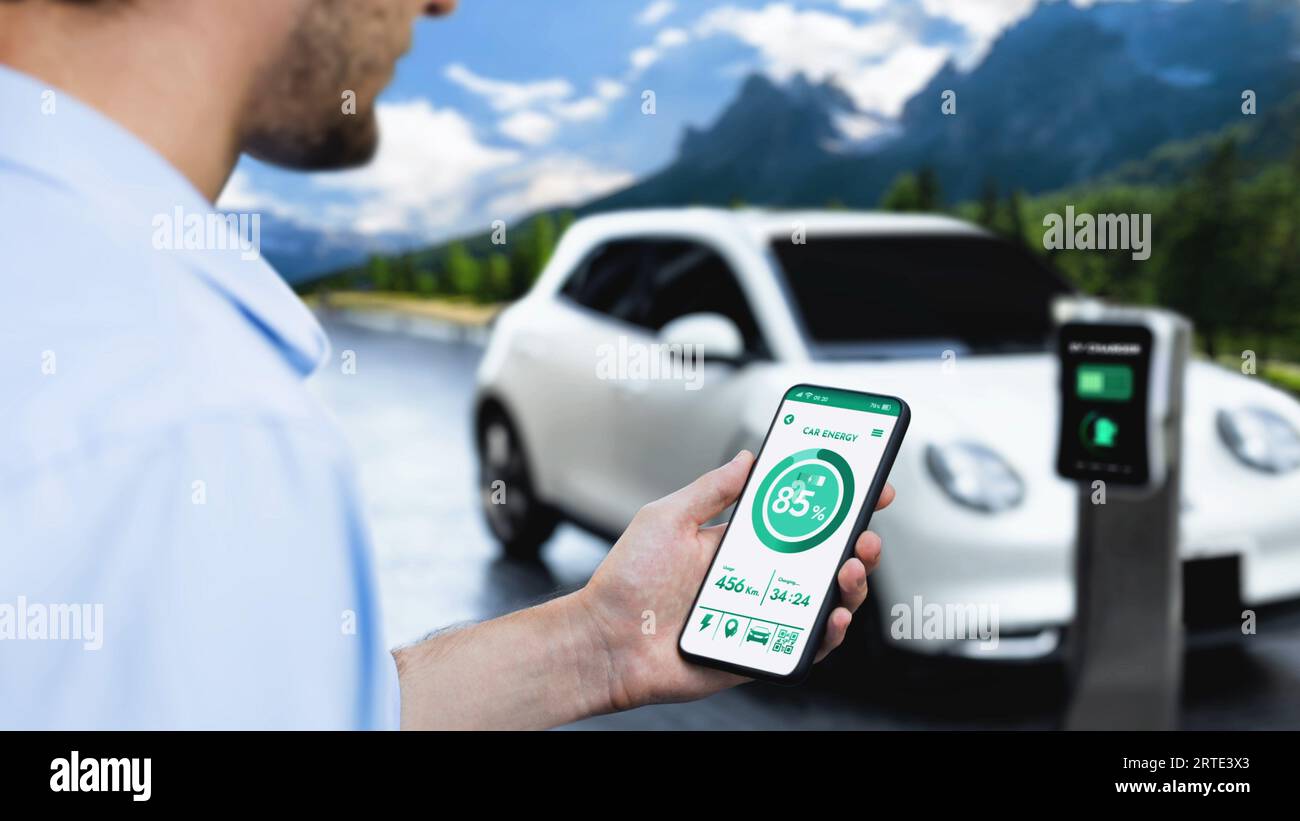 Businessman holding smartphone display battery status interface by ...