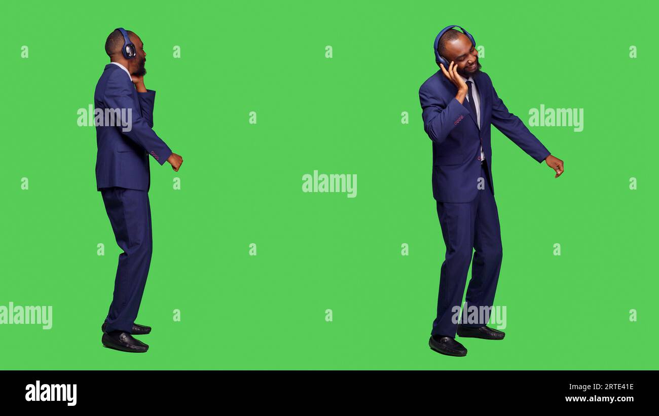 Company employee listening to music and dancing, wearing office suit ...