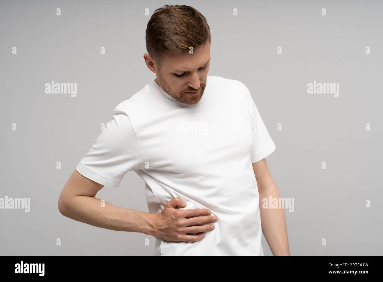 Man feeling pain in right part of abdomen, suffering from spasms on ...