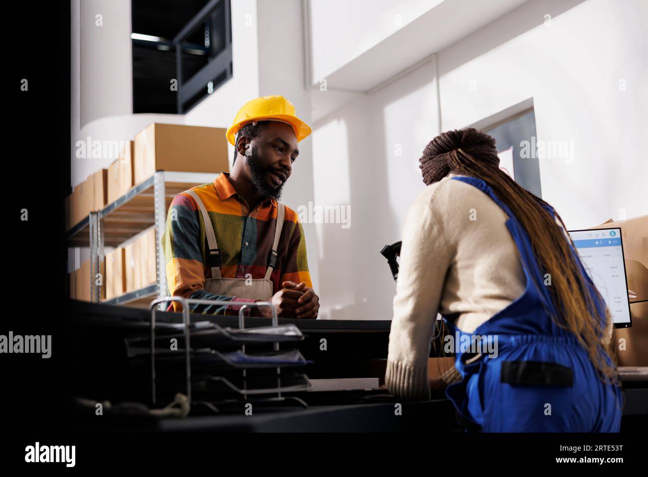 Logistics managers checking merchandise inventory on computer at ...
