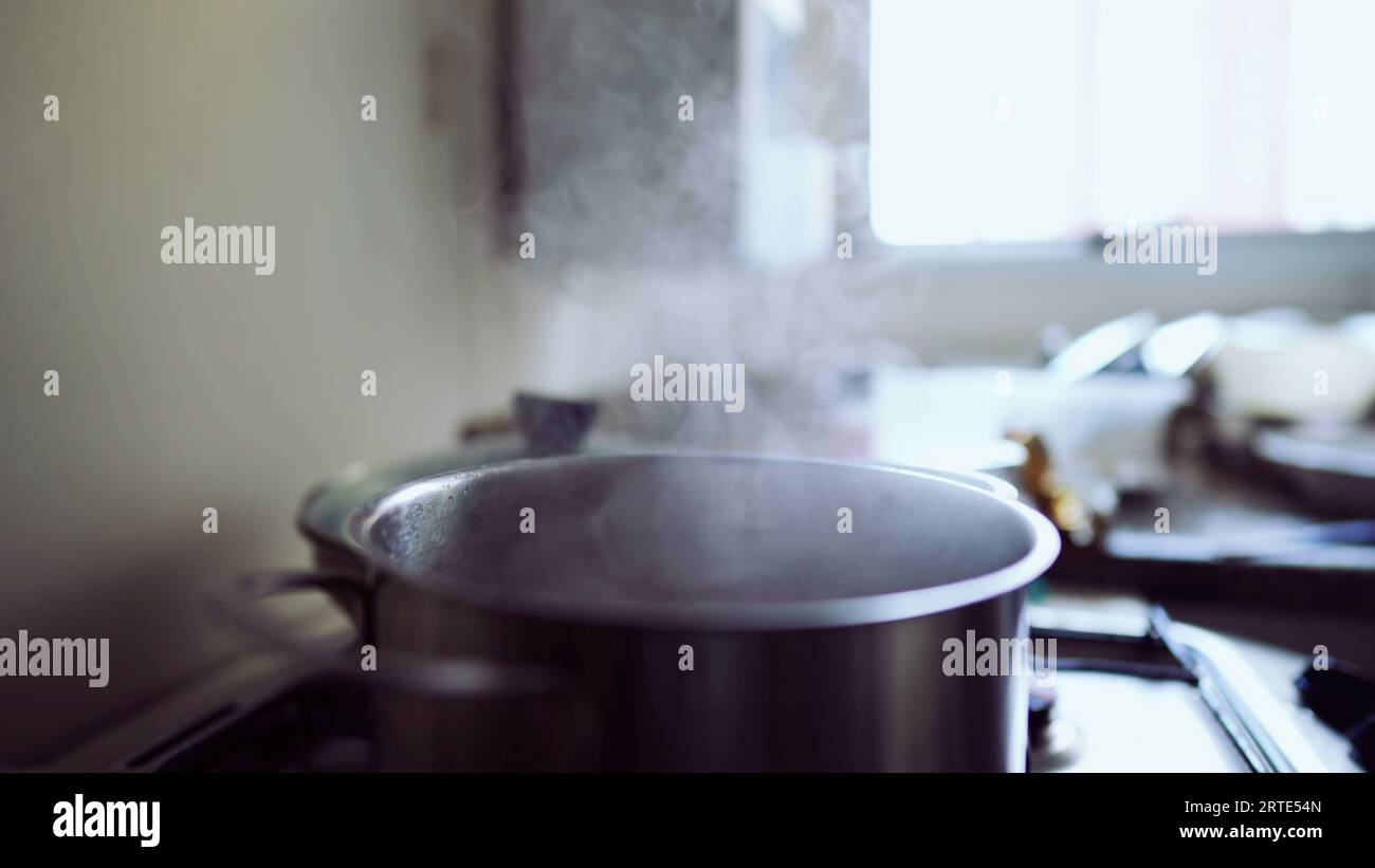 Steam Rising from Metal Pan on Kitchen Stove, Cooking Process Underway ...