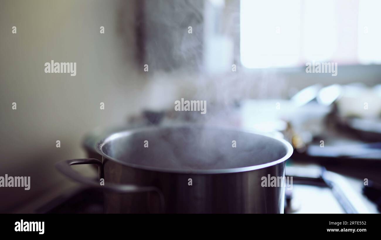 Steam Rising from Metal Pan on Kitchen Stove, Cooking Process Underway ...
