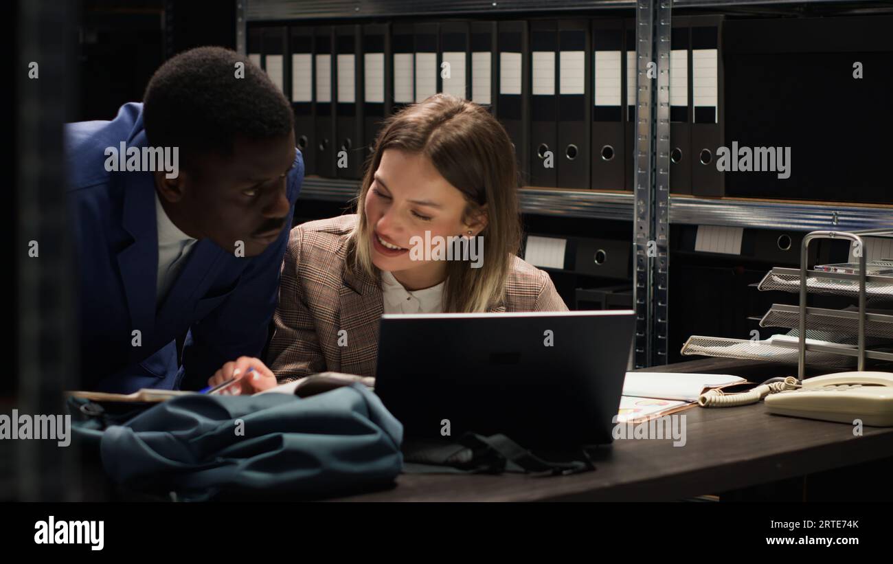 Female and male private detectives collaborate in incident room ...