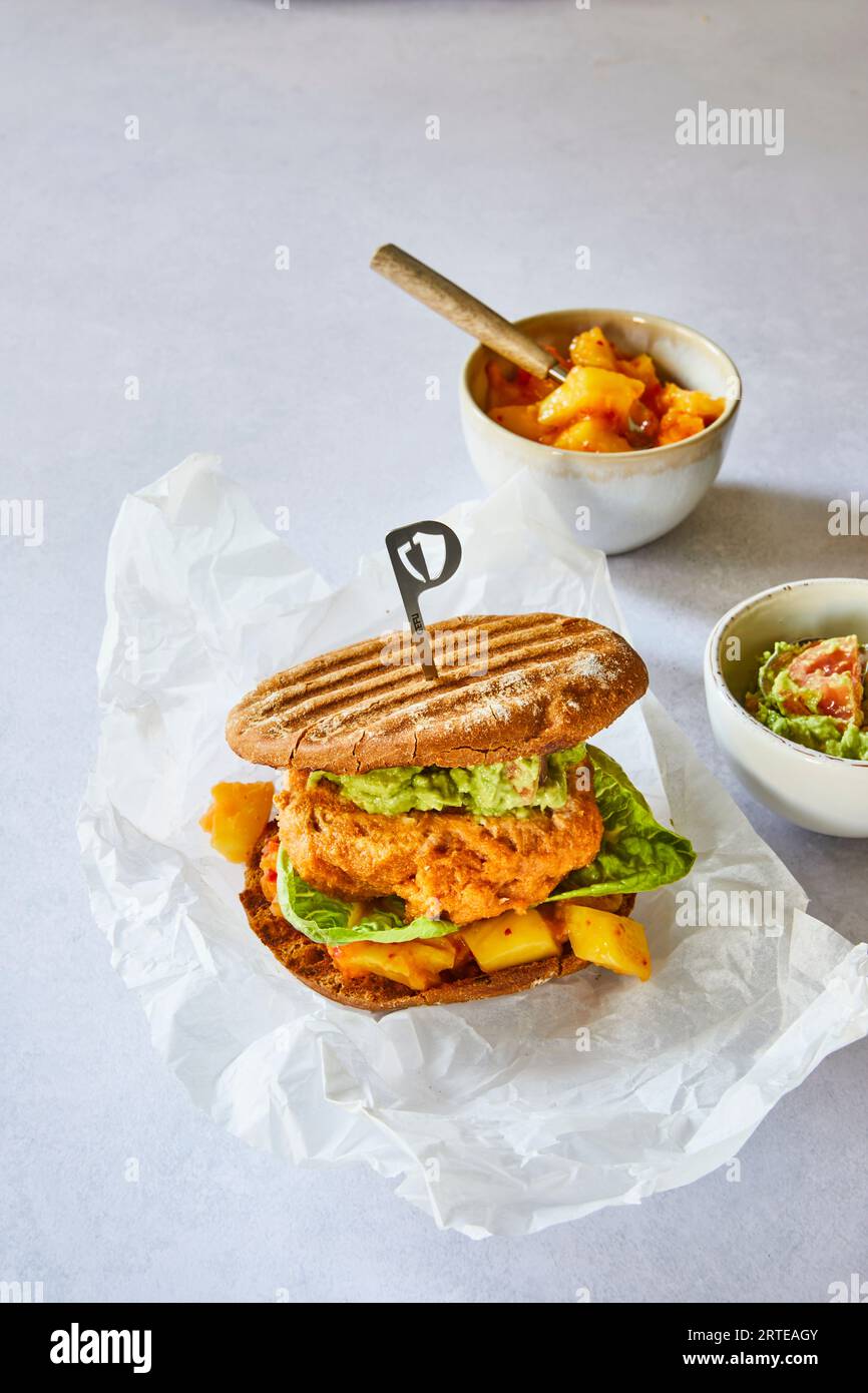 Chicken burger with mango salsa and guacamole Stock Photo - Alamy