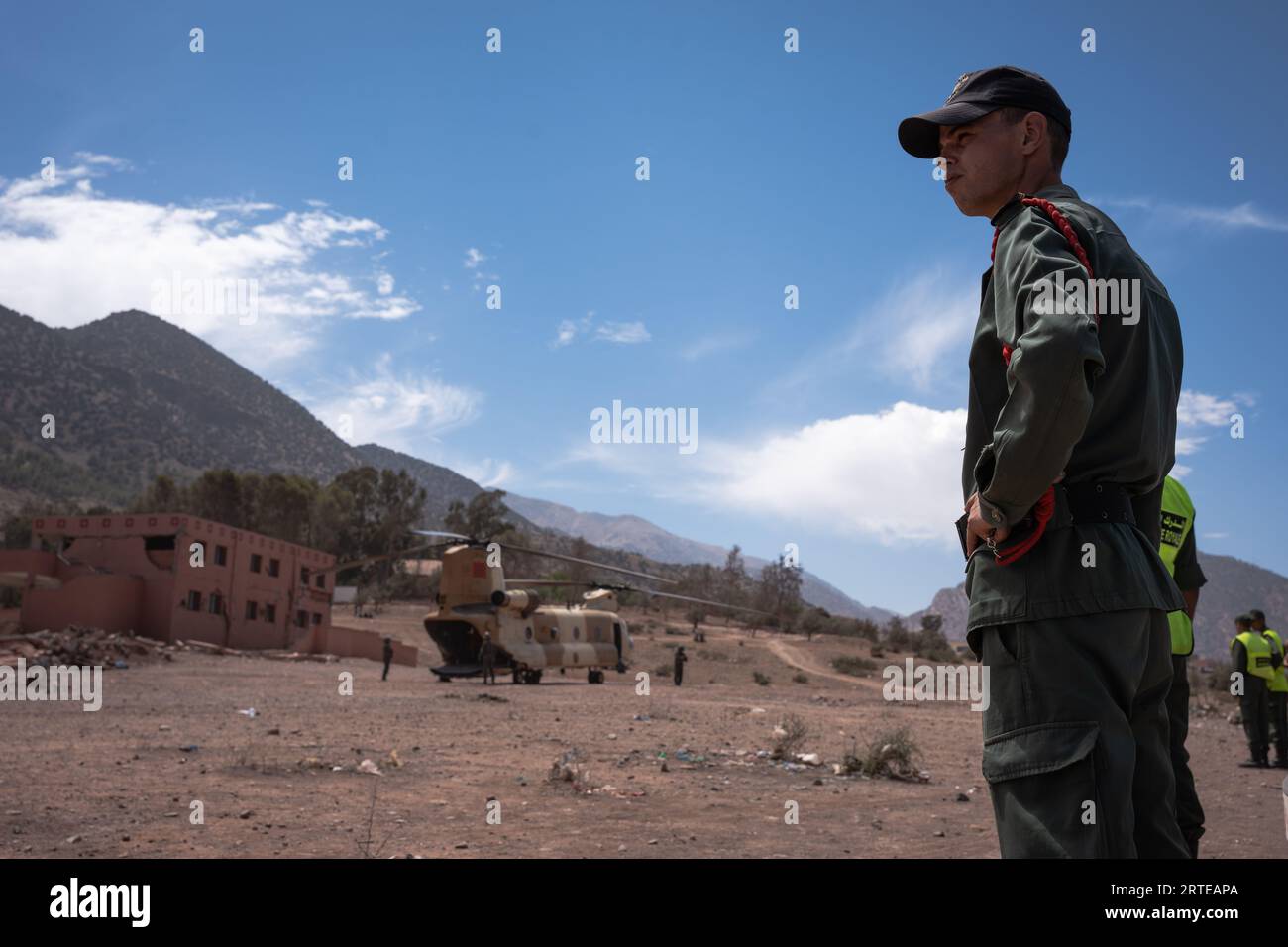 A Moroccan officer is seen next to the helicopter which is assisting in ...