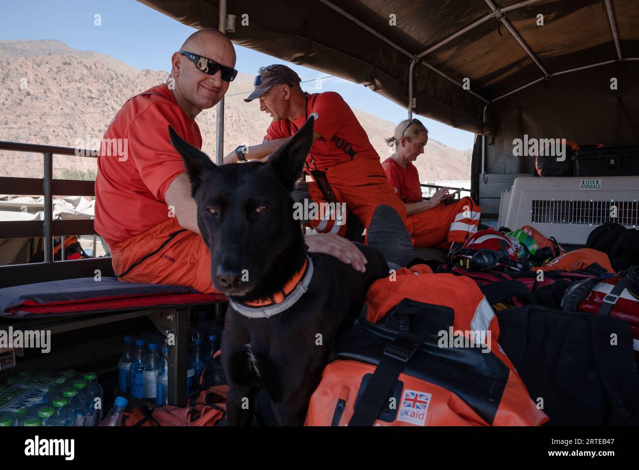 A rescue dog sits next to the members of the ISAR, rescue team deployed ...