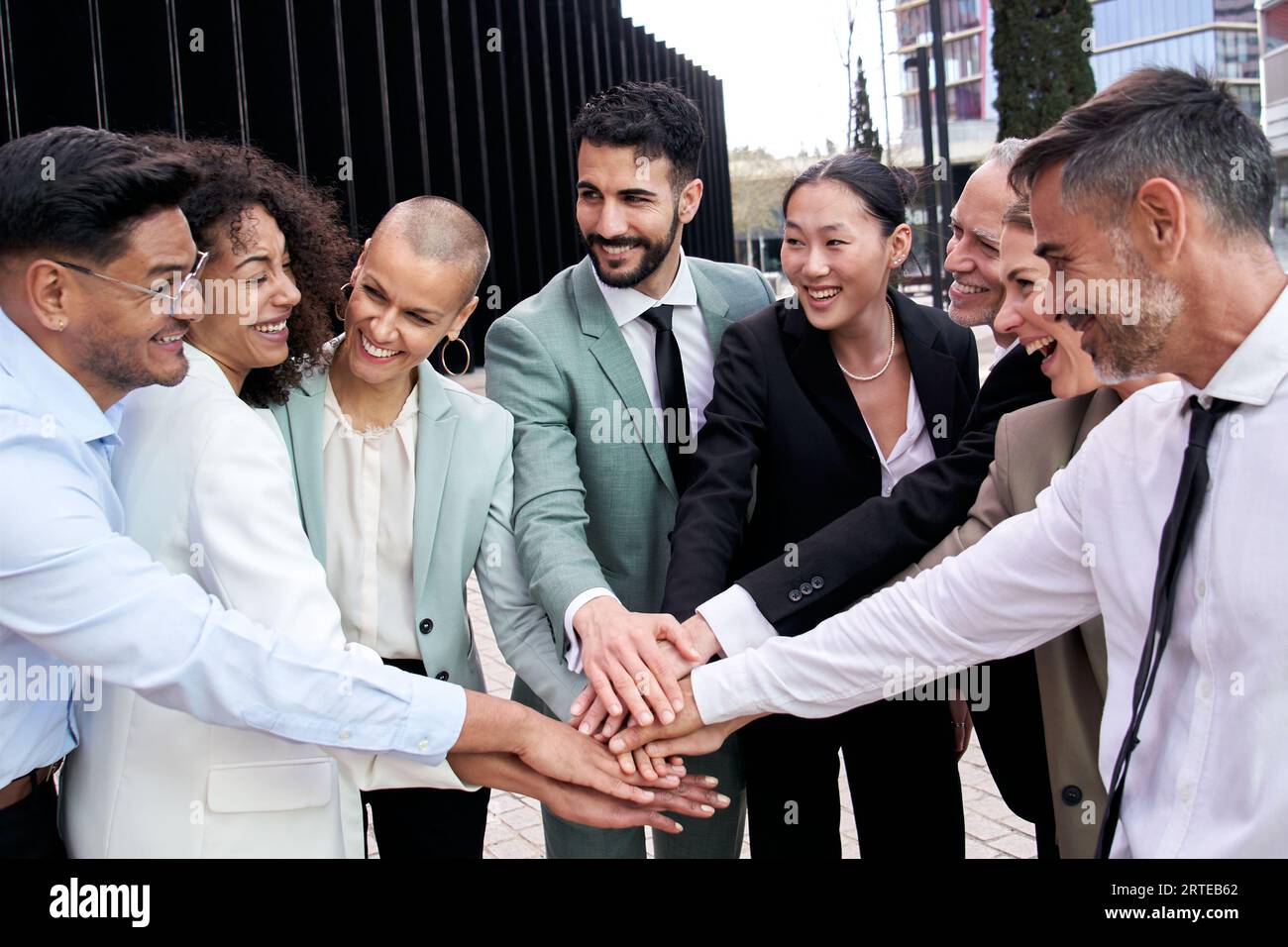 Multicultural happy business group team building team joining hands ...