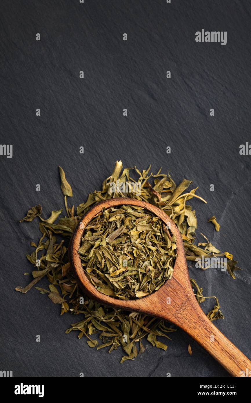 Dried rue leaves in the spoon - Ruta graveolens Stock Photo - Alamy