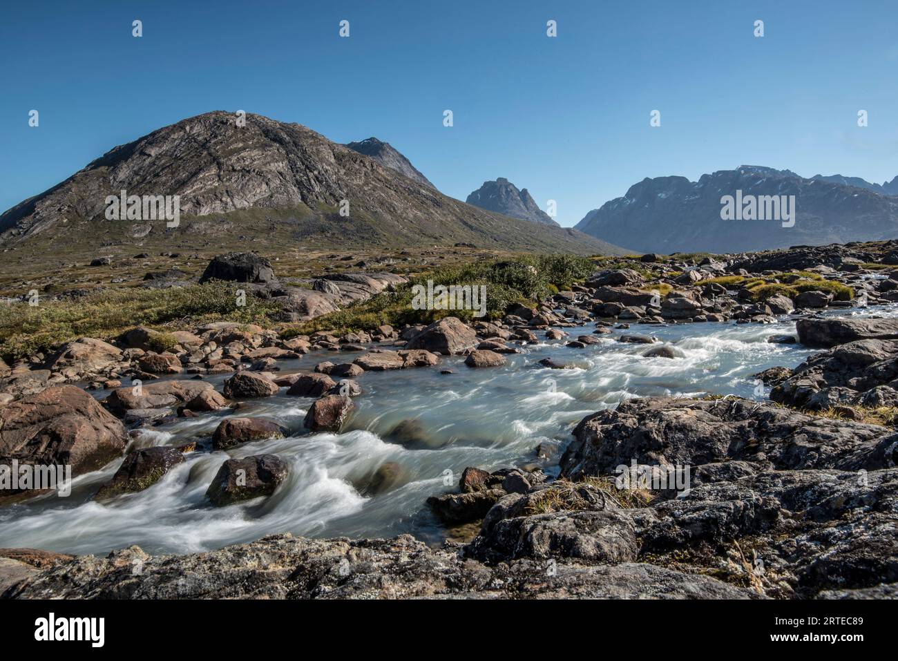 Scenic view of a glacial stream flowing through the mountains in the ...