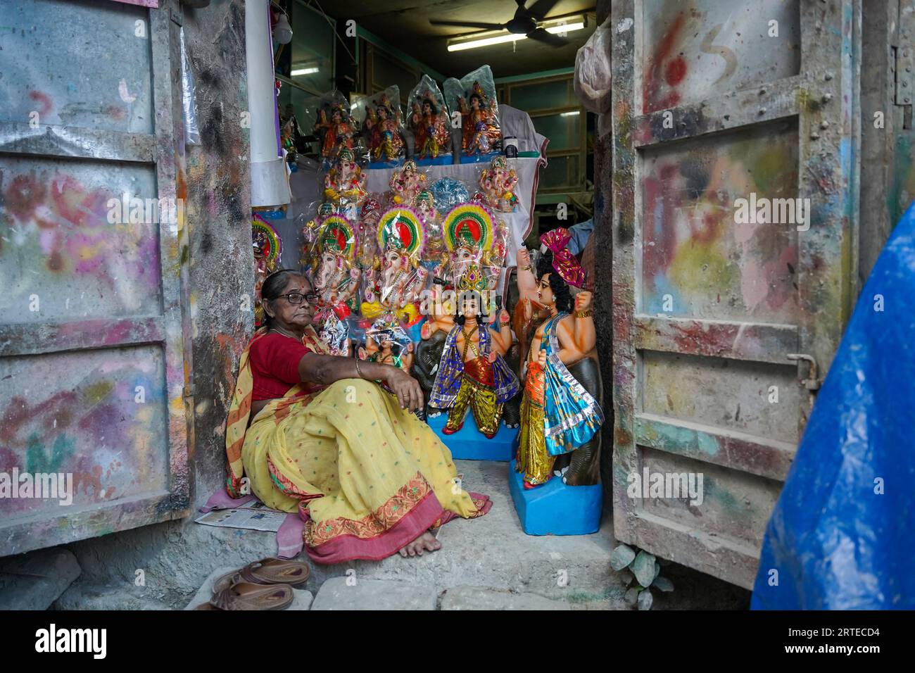 An elderly lady sells clay idols of Hindu god Lord Ganesha & Viswakarma ...