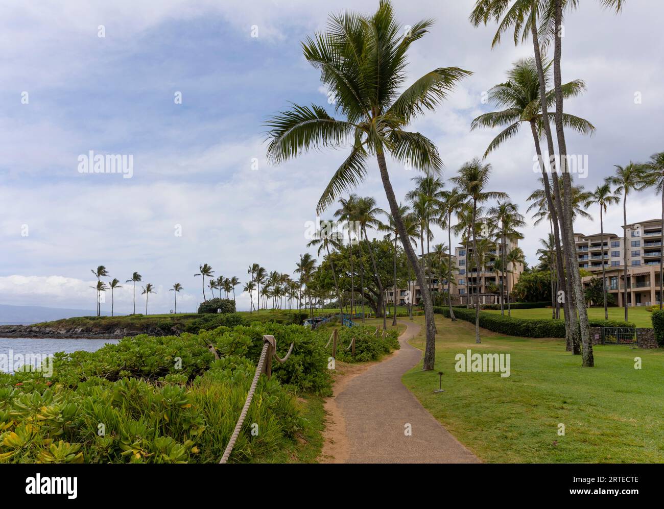 Walkway along the shore in front of a hotel resort at Kaanapali Beach ...