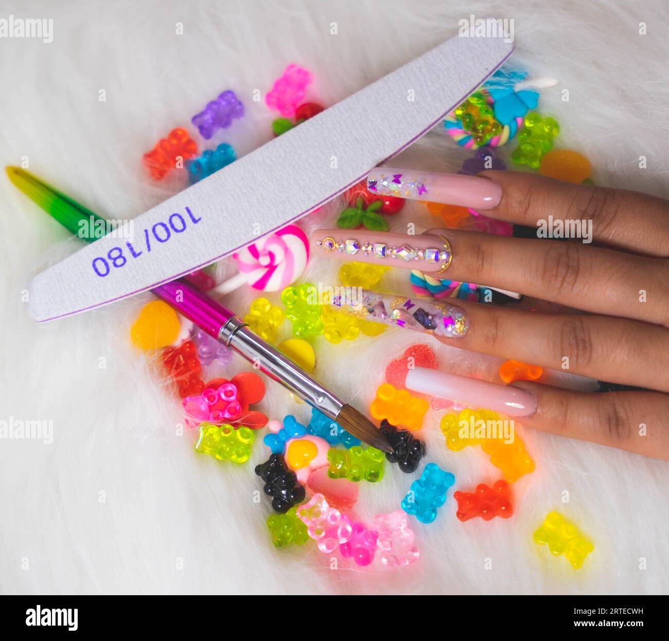 Hand with long nails and colorful figures Stock Photo - Alamy