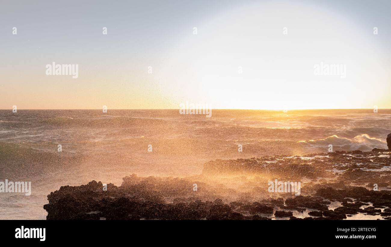 Waves hitting beach sunset shot hi-res stock photography and images - Alamy