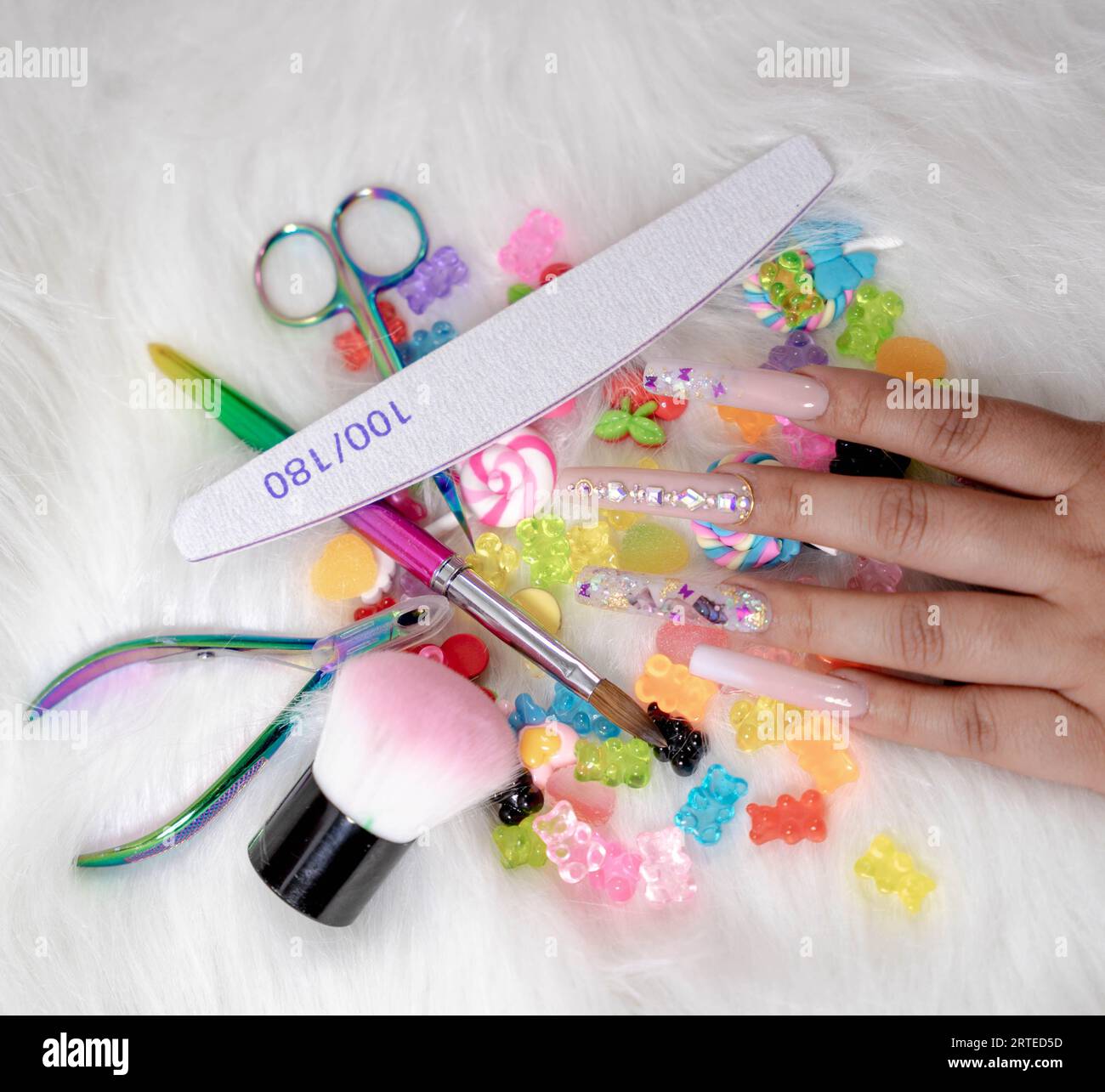 Hand with long nails and colorful figures Stock Photo - Alamy