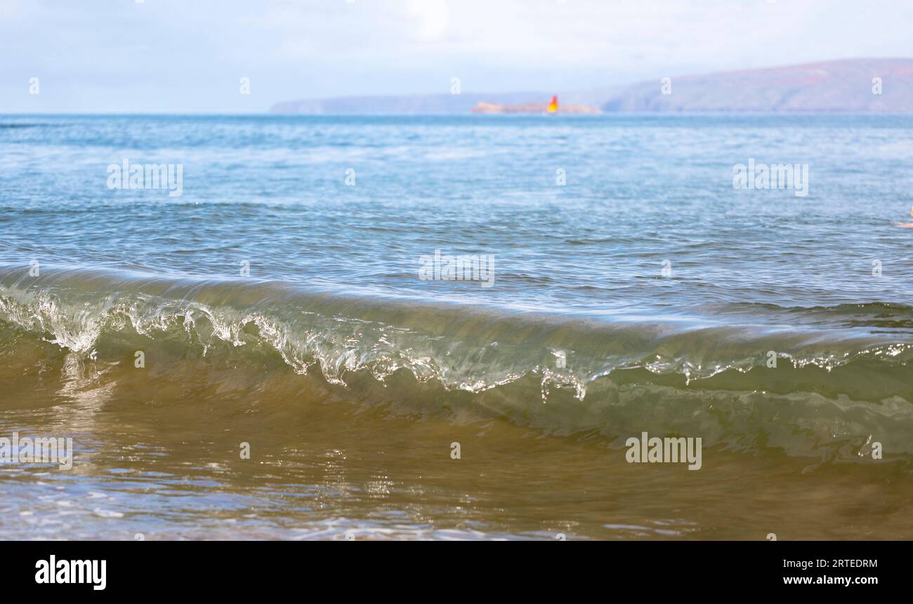 Close-up of rolling, ocean wave cresting along the shore of Kamaole 2 ...