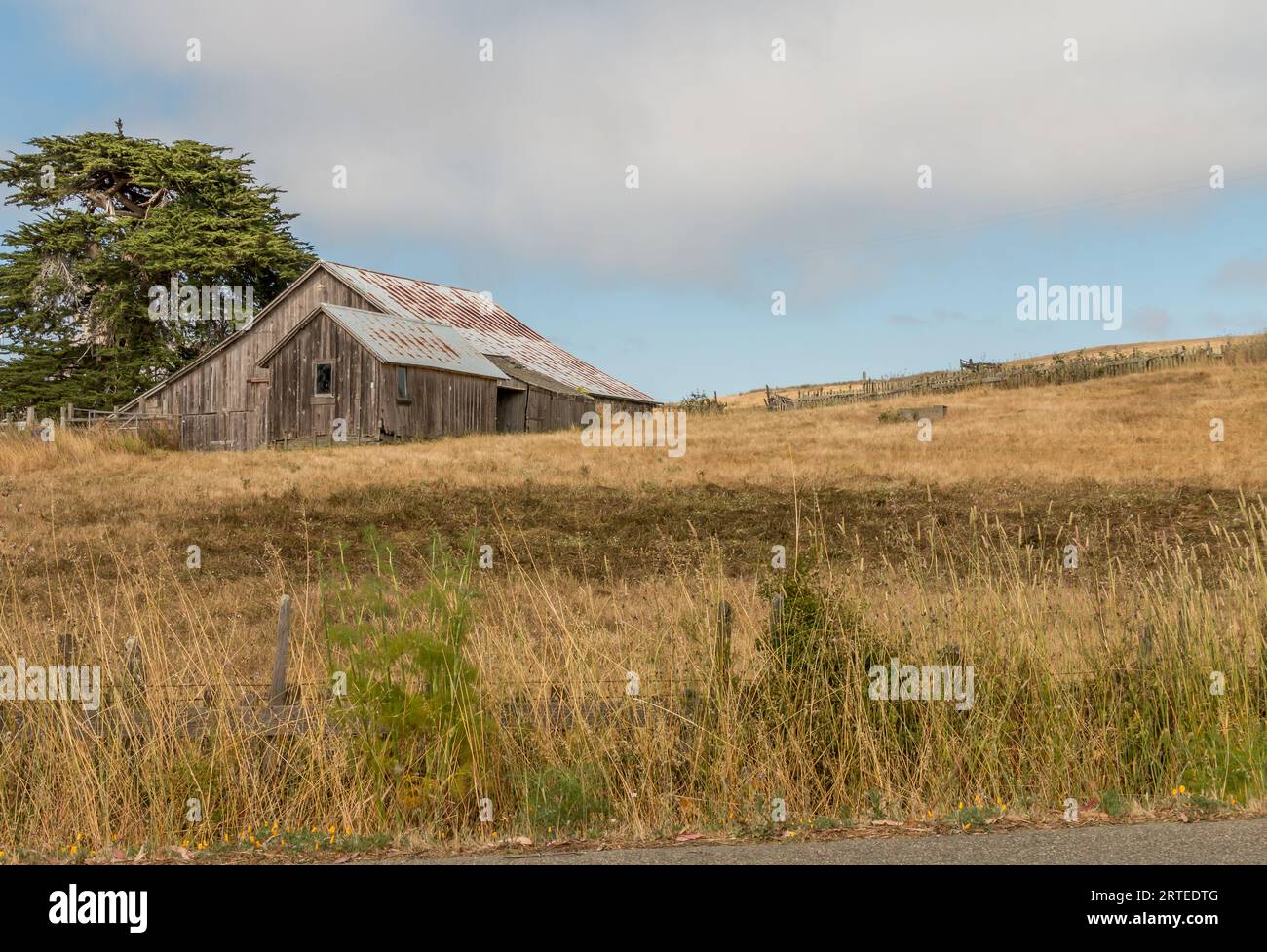 An old wooden barn is located on the left side of the photo. It is in a ...