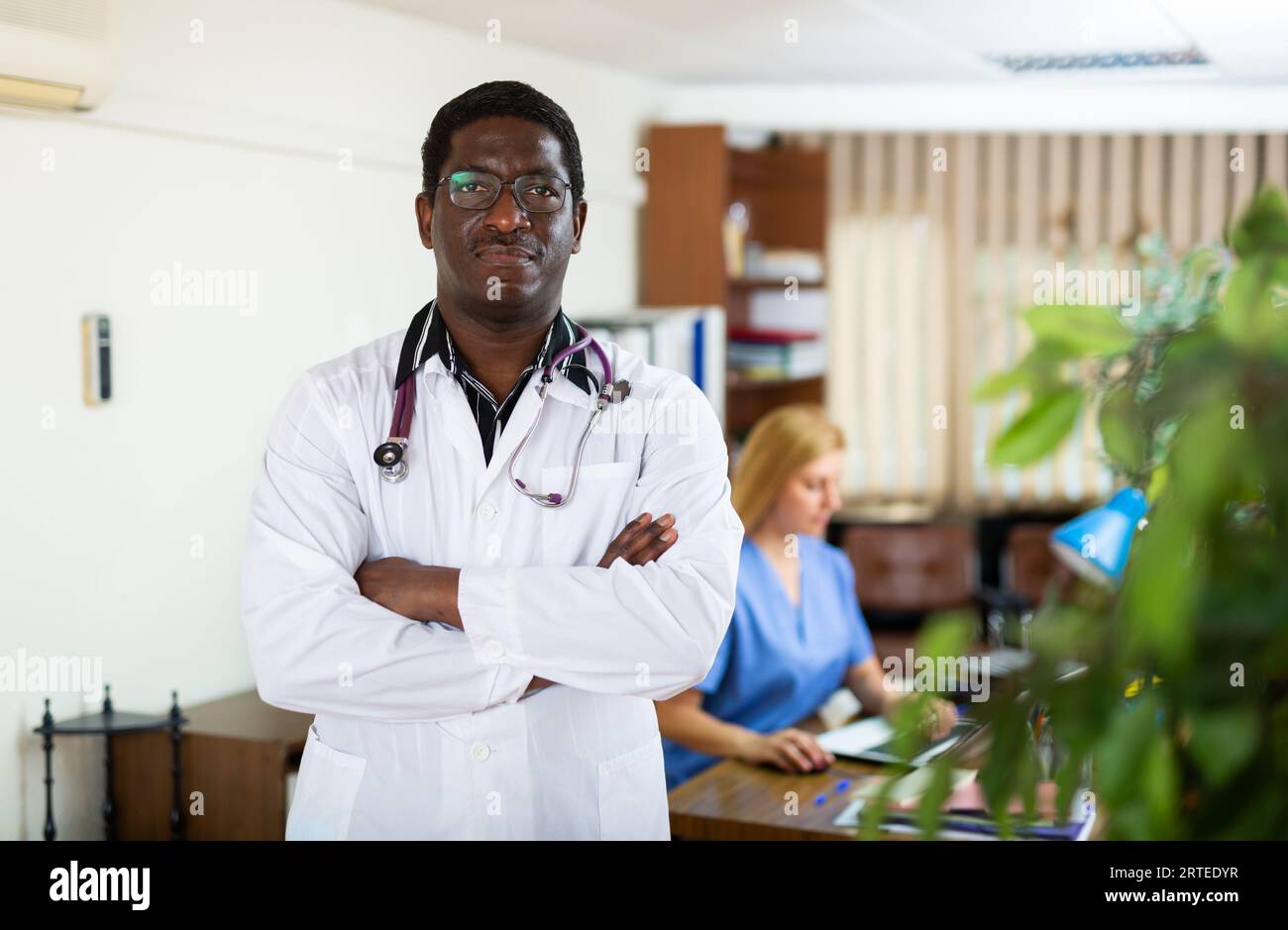 African american man doctor standing in medical office making welcoming ...