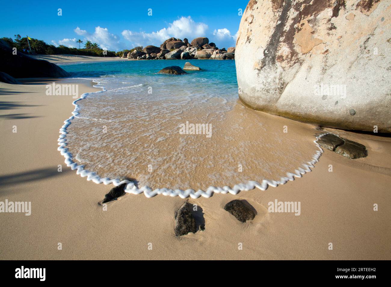 Stunning view of the sandy beach with surf forming a zigzag pattern in ...