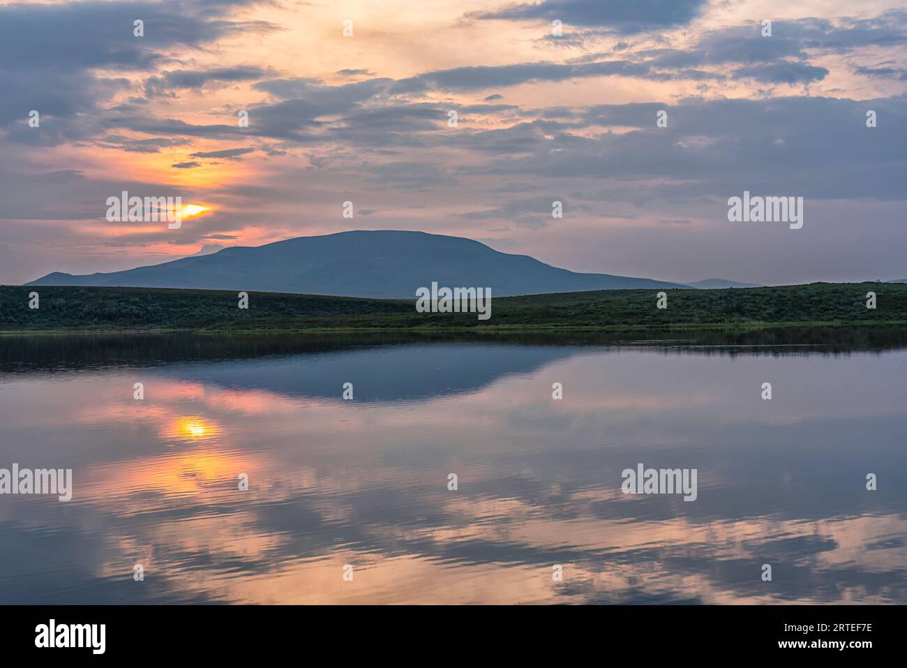A smoky sunset over Two Moose Lake along the Dempster Highway; Yukon ...